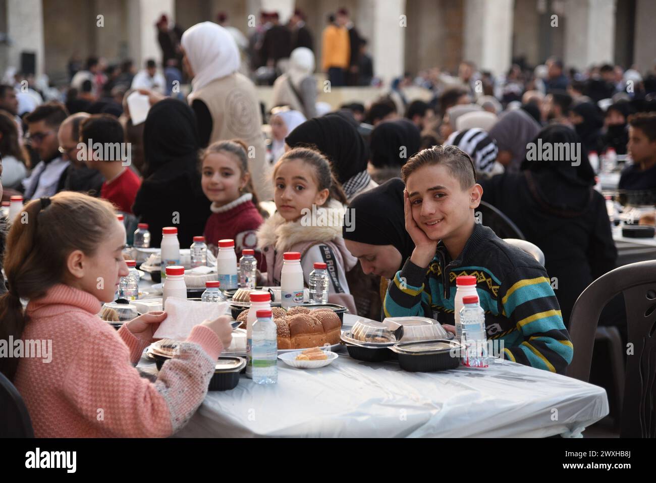 Aleppo, Syria. 30th Mar, 2024. People attend an iftar banquet at the ...