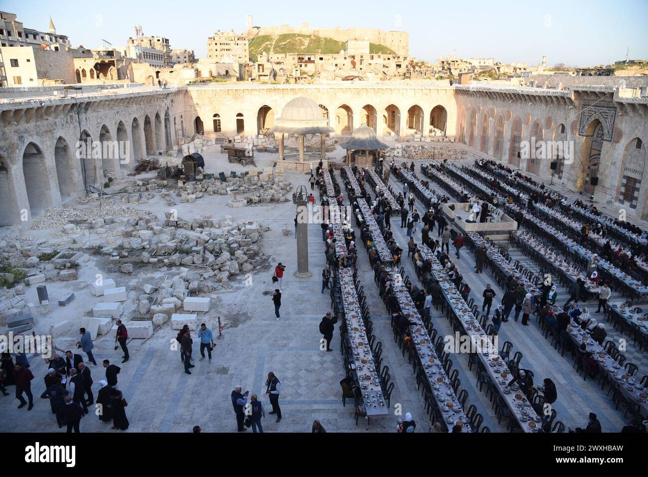 Aleppo, Syria. 30th Mar, 2024. People attend an iftar banquet at the ...