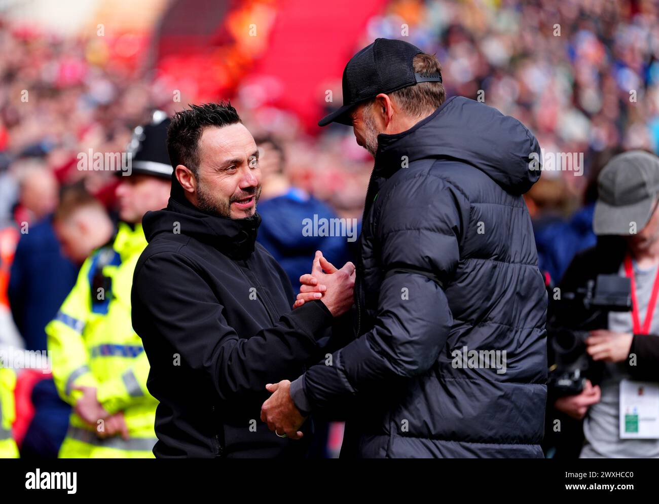Brighton and Hove Albion manager Roberto De Zerbi (left) shakes hands ...