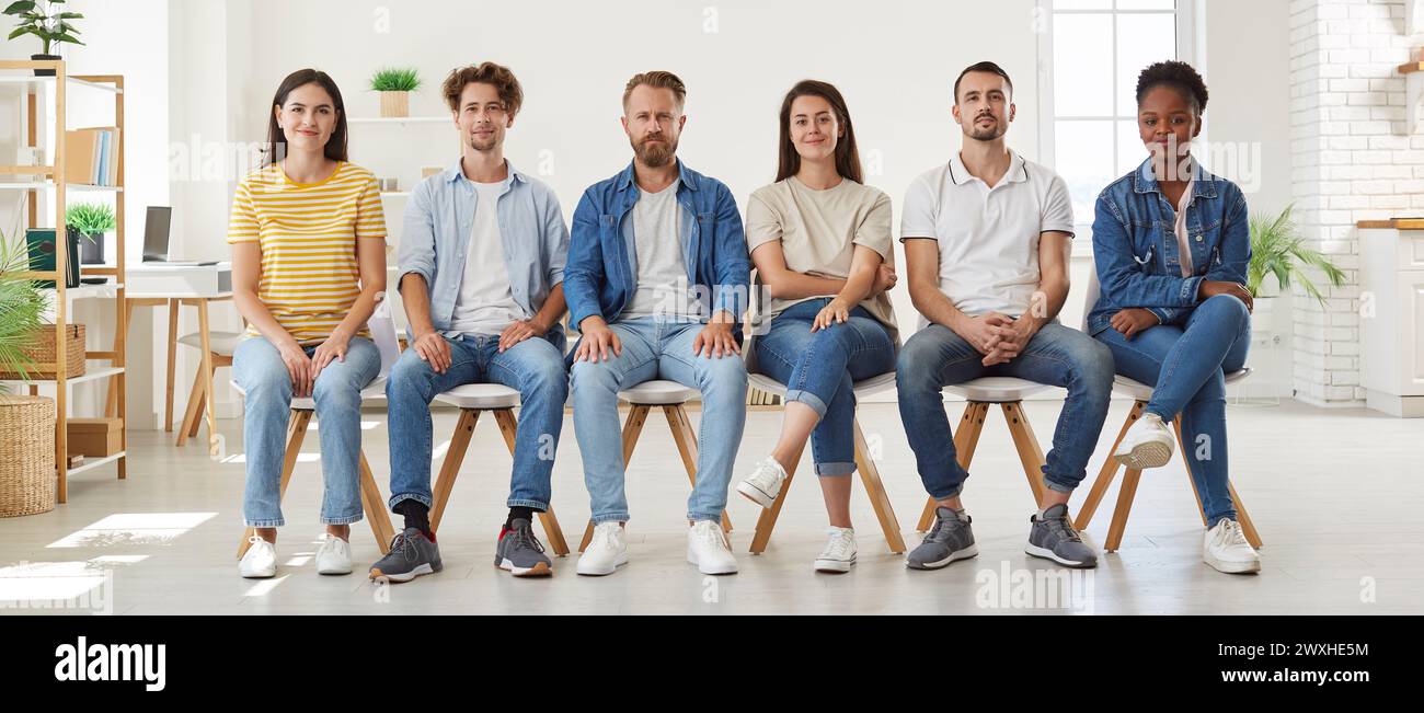 Group of diverse people sitting on chairs in row Stock Photo - Alamy