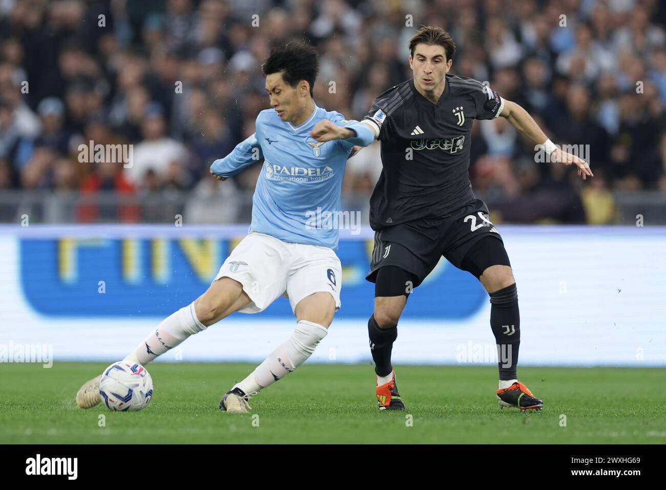 Lazio's Japanese midfielder Daichi Kamada challenges for the ball with ...