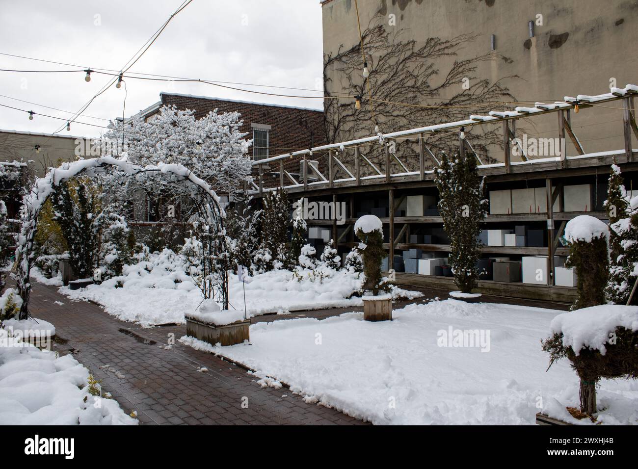 Snow-covered sidewalk adjacent to tall buildings in winter Stock Photo ...