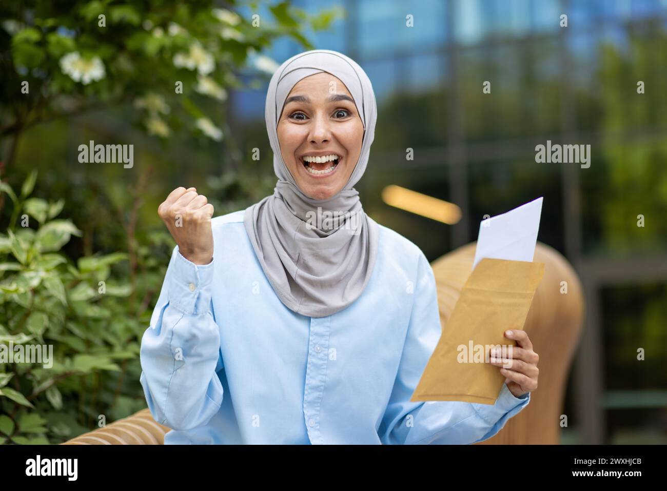 Vibrant image of a joyful Muslim woman wearing a hijab, exuberantly ...