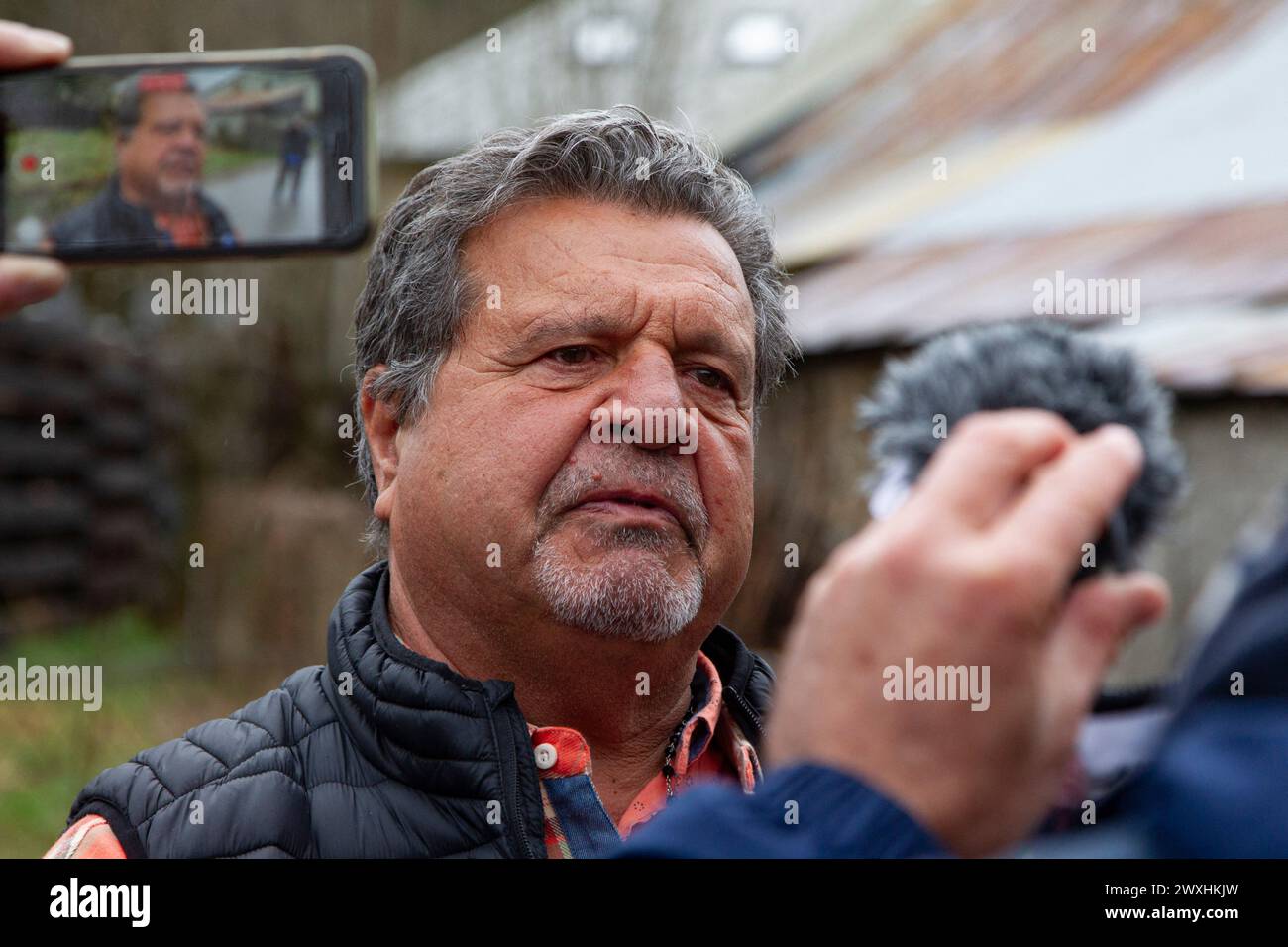 Gilles Thezan, a resident of the village, answers questions from ...