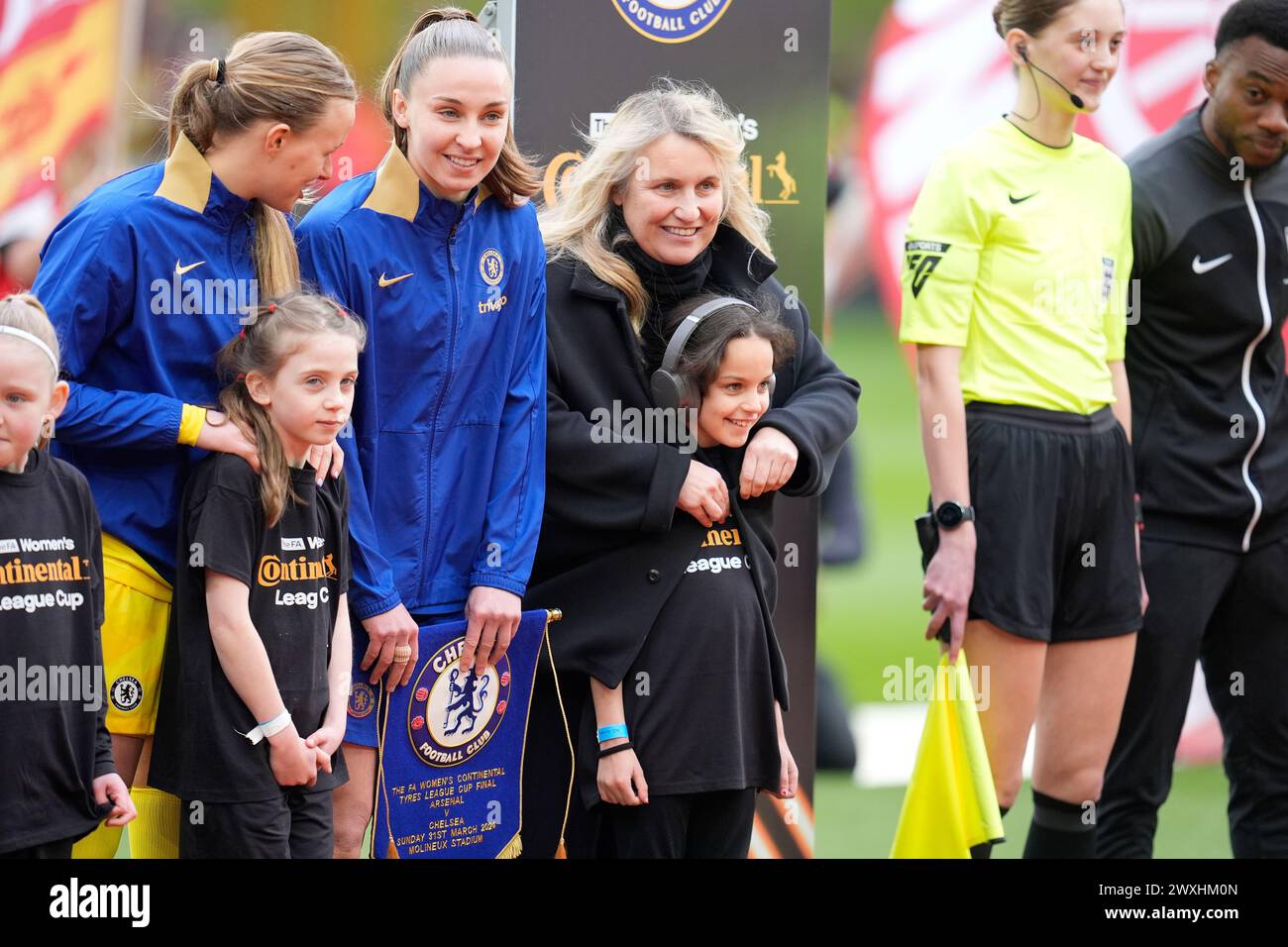 Chelsea manager Emma Hayes uses her jacket to warm up a mascot ahead of ...