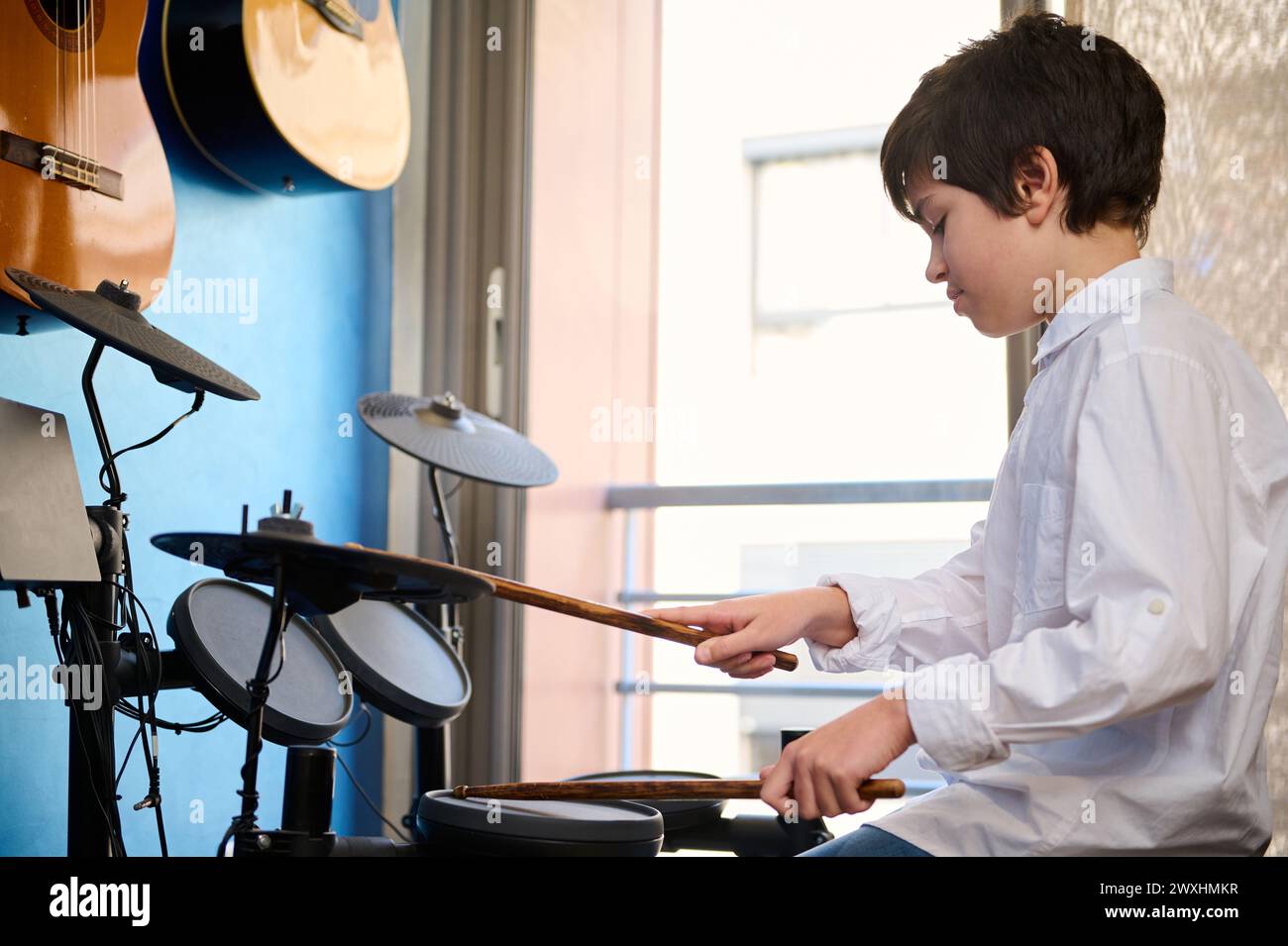 Side portrait of authentic Caucasian handsome teenage boy musician ...