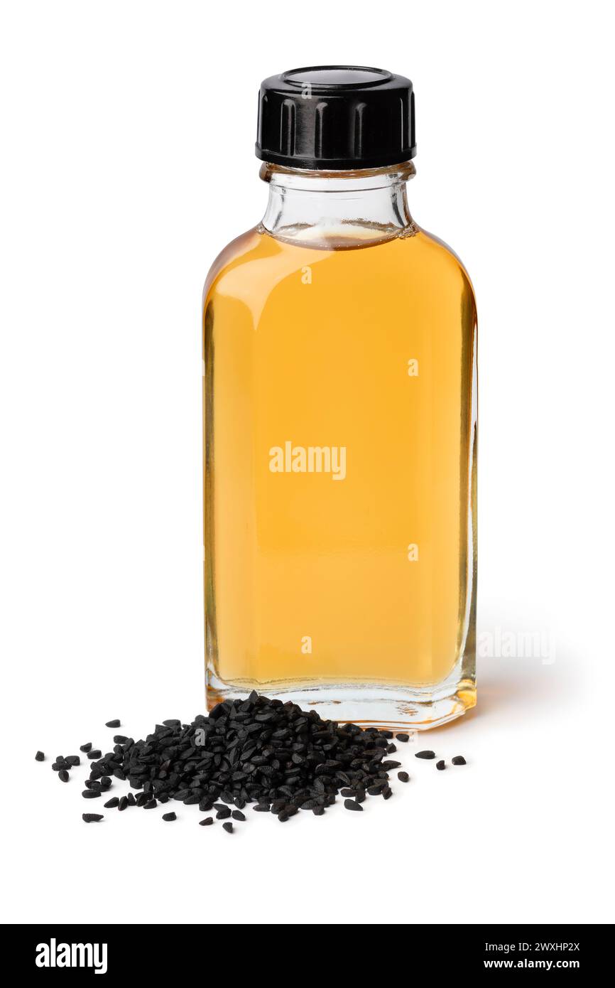 Single Bottle With Nigella Oil And A Heap Of Nigella Seed Isolated On White Background Close Up