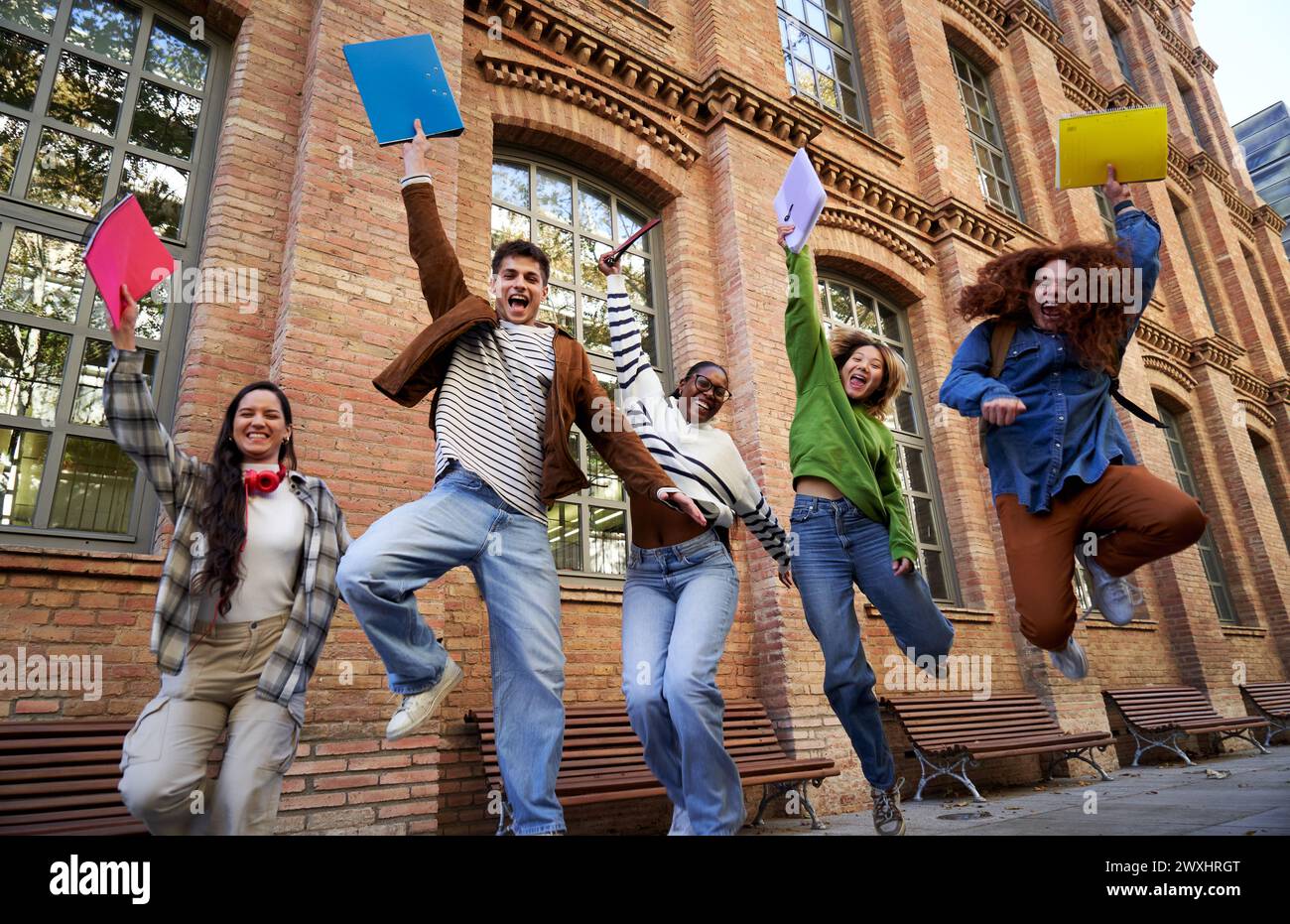 Happy group of multiethnic students celebrating the last day of school ...