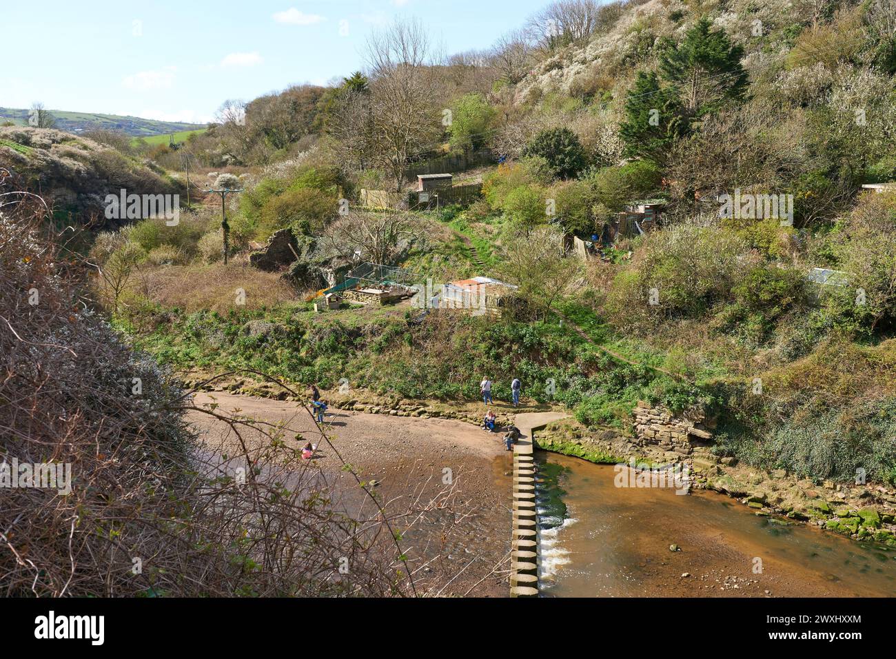 Stepping stone bridge spanning a shallow stream in Staithes, Yorkshire ...