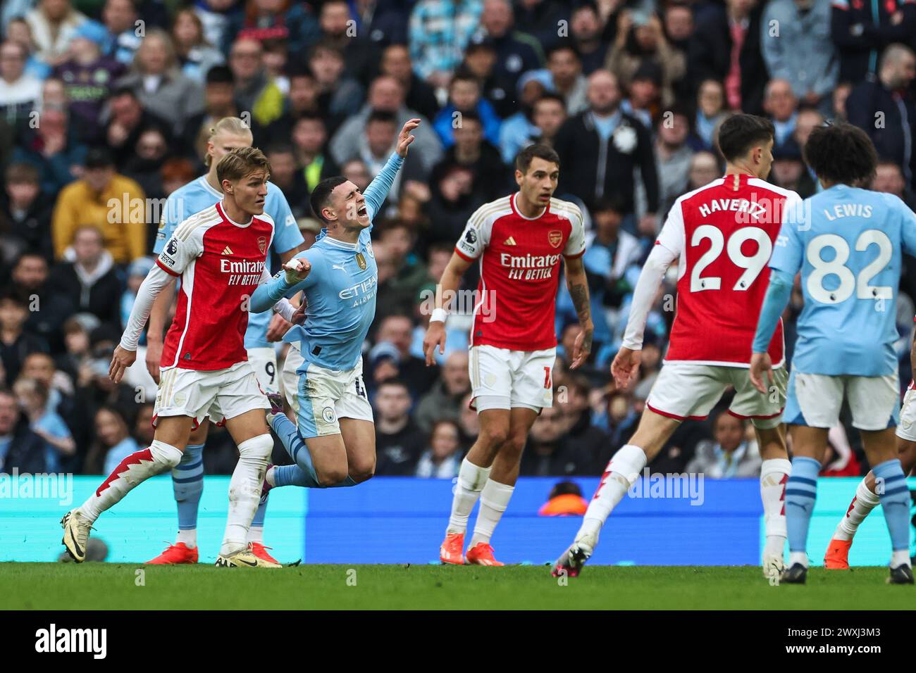 Phil Foden of Manchester City is fouled by Martin Ødegaard of Arsenal ...