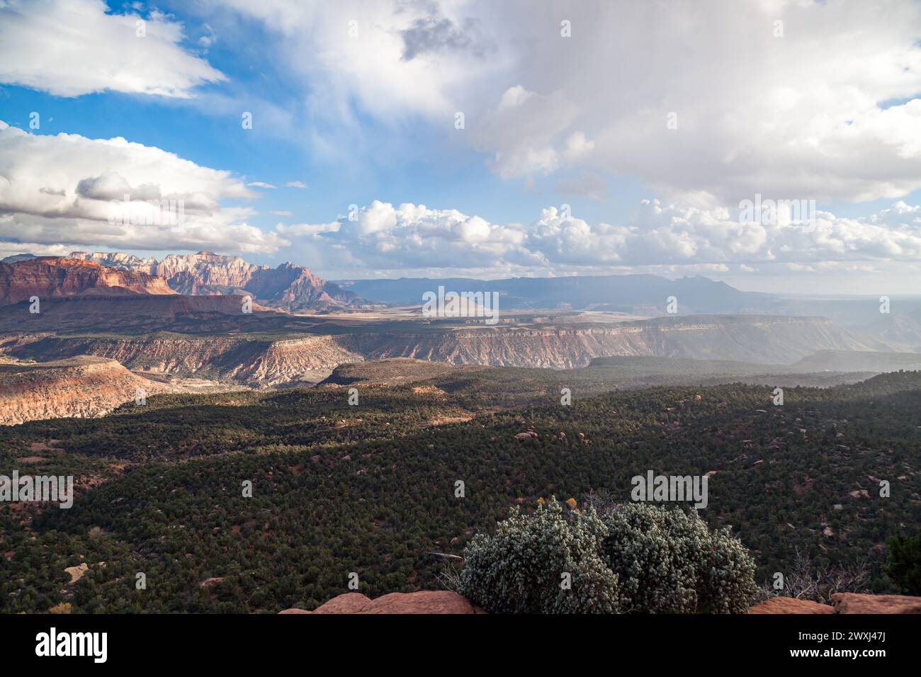 A sweeping landscape view of the distant mountains of Zion National ...