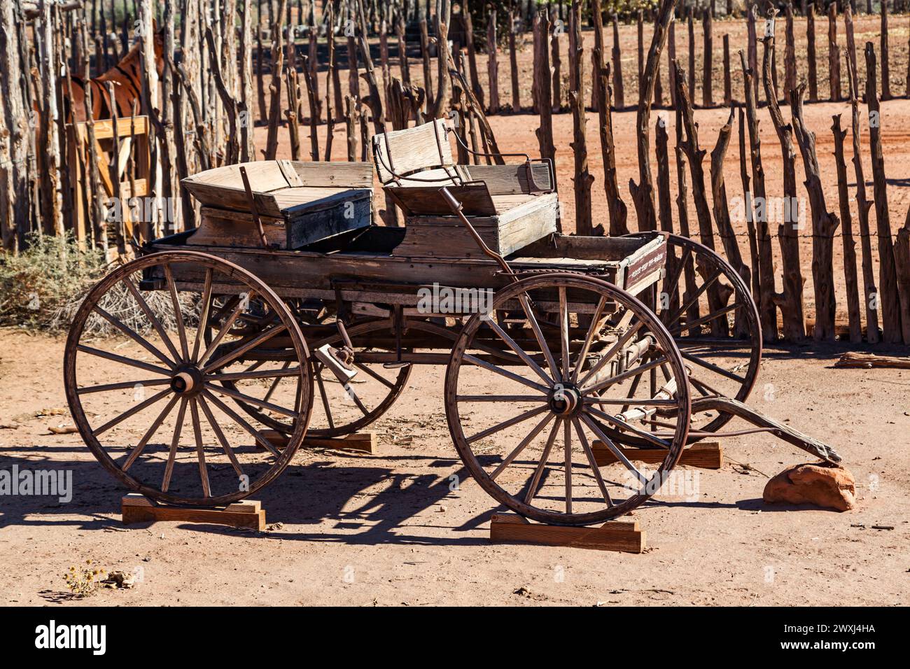 The frame and wheels of an old wagon displayed in the desert of the ...