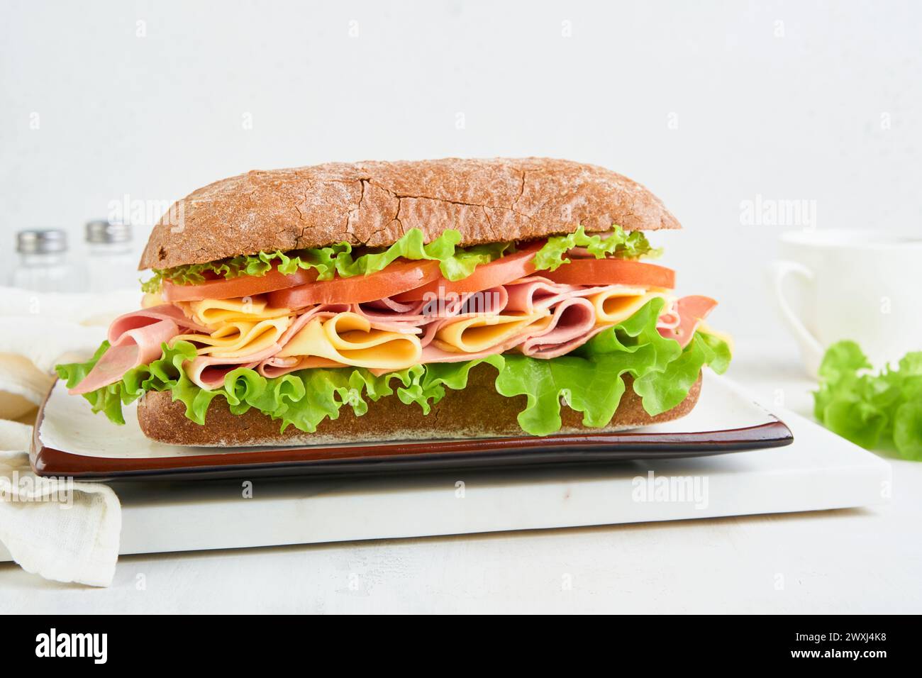 Sandwich. One fresh big submarine sandwich with ham, cheese, lettuce ...