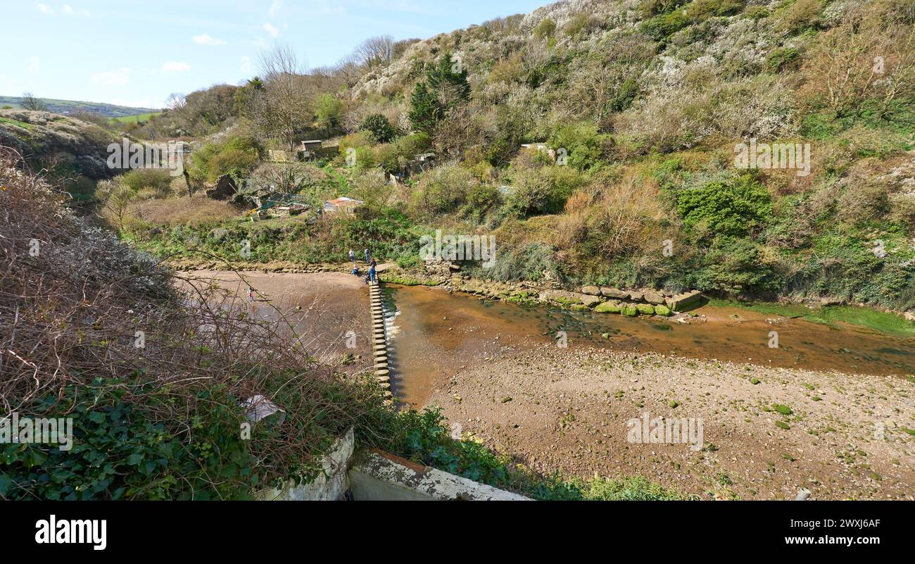 Stepping stone bridge spanning a shallow stream in Staithes, Yorkshire ...
