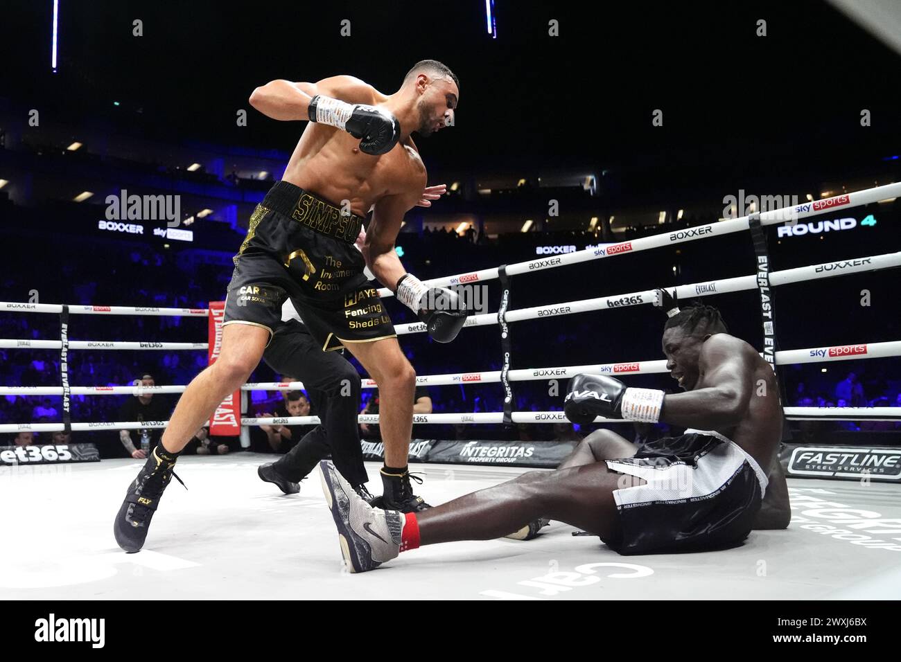 Dulla Mbabe is knocked down during his super middle weight bout against Callum Simpson (left) at ...