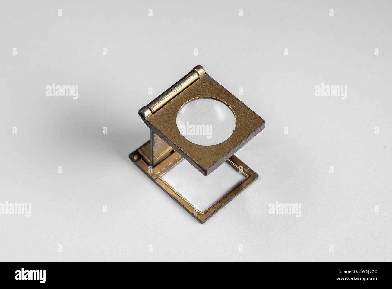 old lithographic loupe with metal frame and brass-toned glass lens ...