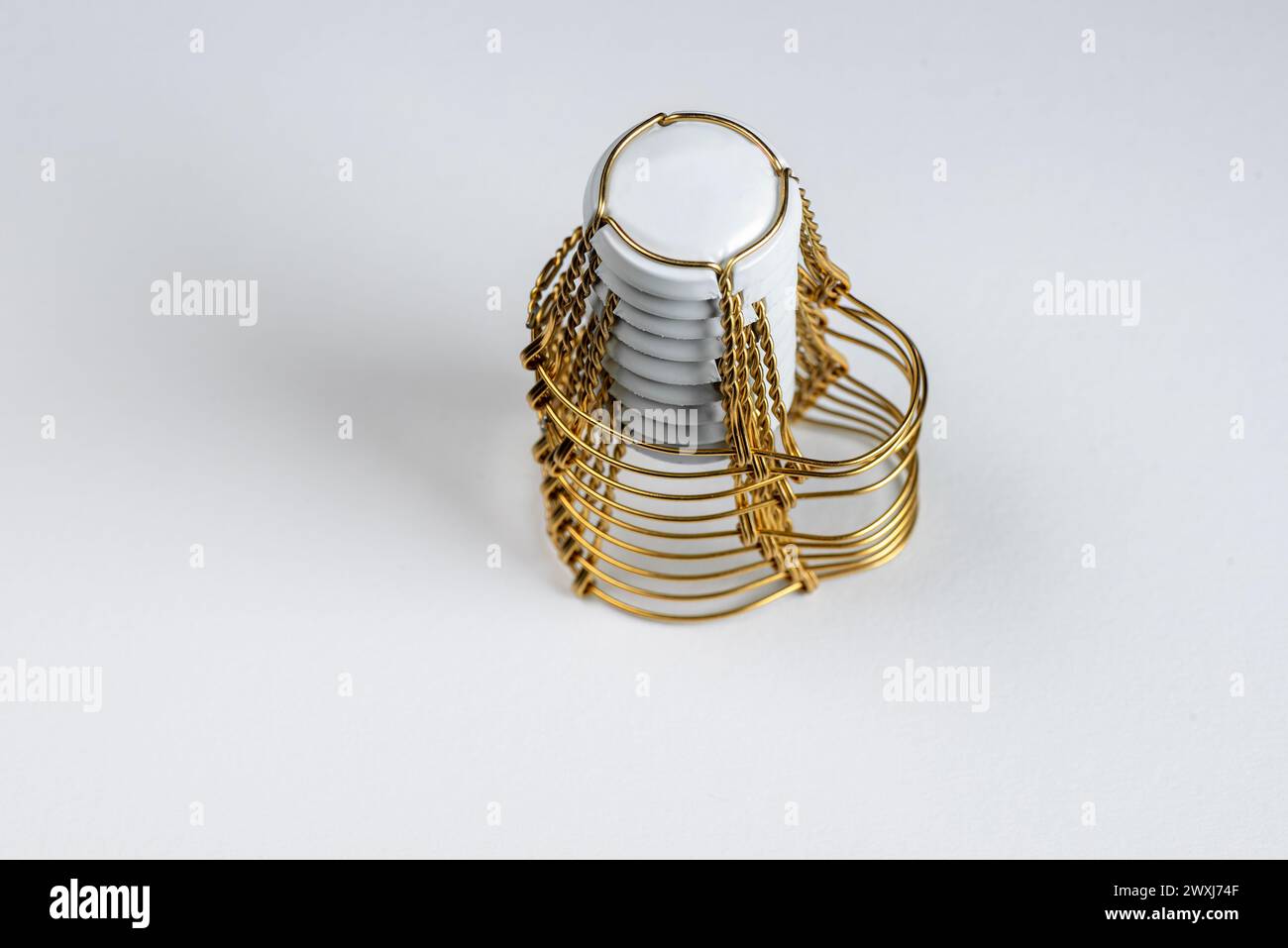 Golden wire capsules or gold foil for sparkling wine champagne Stock Photo - Alamy