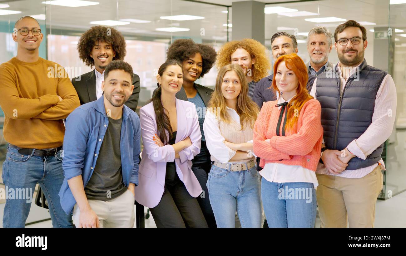 Group of colleagues smiling at camera in a coworking space Stock Photo ...