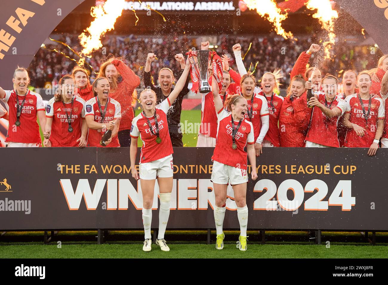 Arsenal’s Leah Williamson (centre left) and Kim Little lift the trophy ...