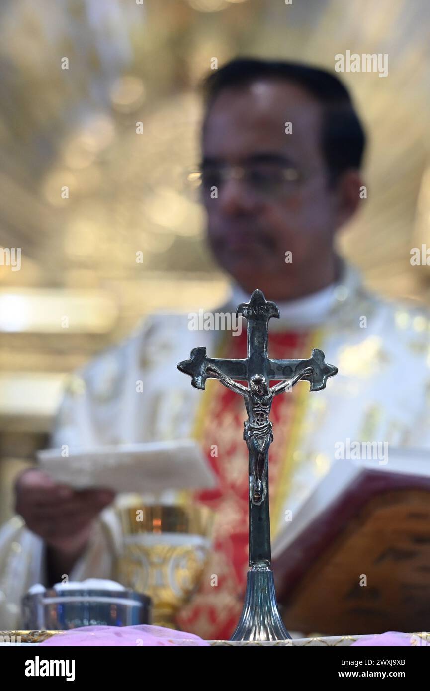 NOIDA, INDIA - MARCH 31: Priest leads prayers on the occasion of Easter ...