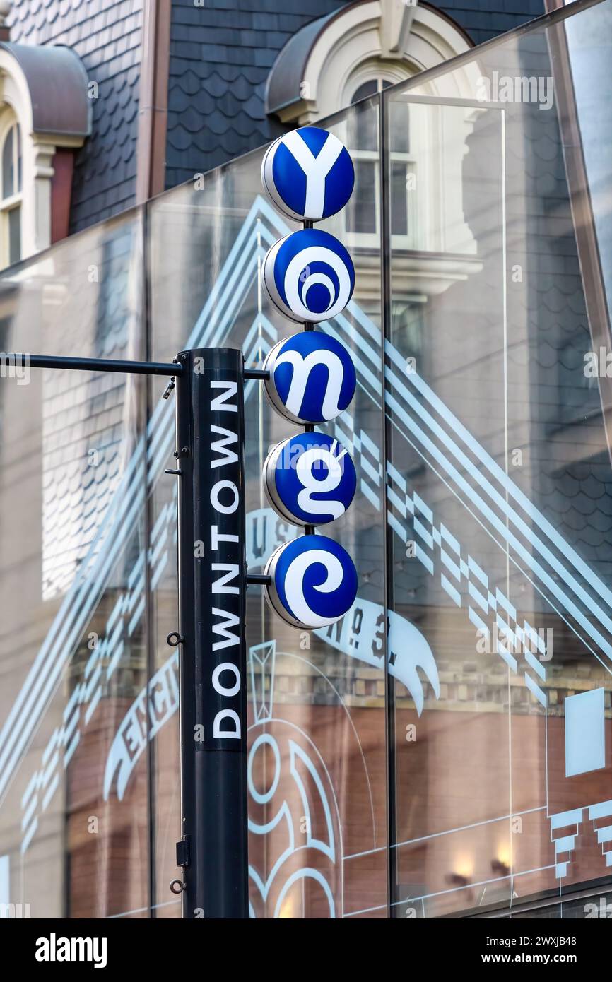 Sign of downtown Yonge Street by the glass facade of Engine House ...
