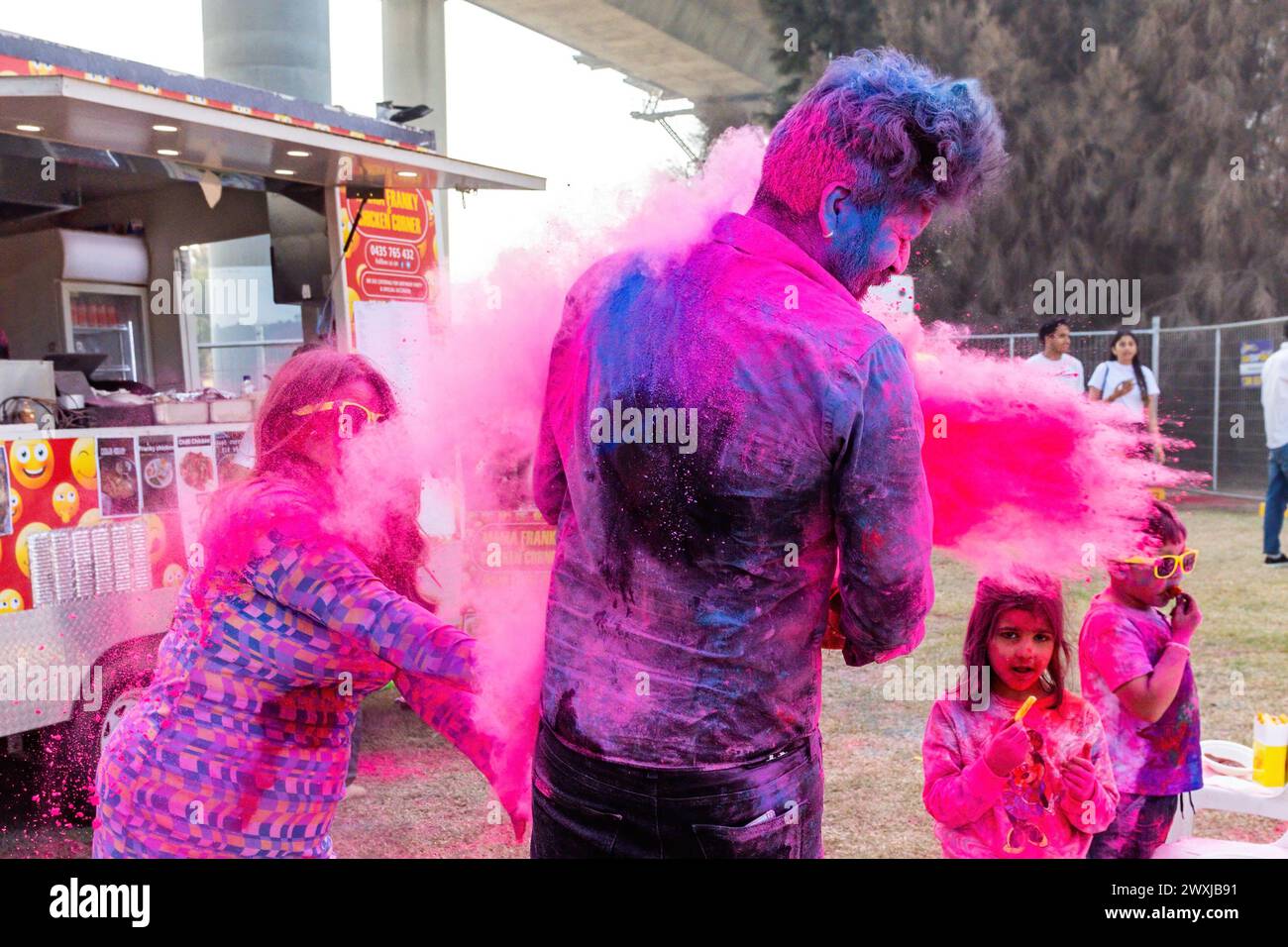 Melbourne, Australia. 31st Mar, 2024. A man is hit by a huge handful of pink powder thrown by a ...