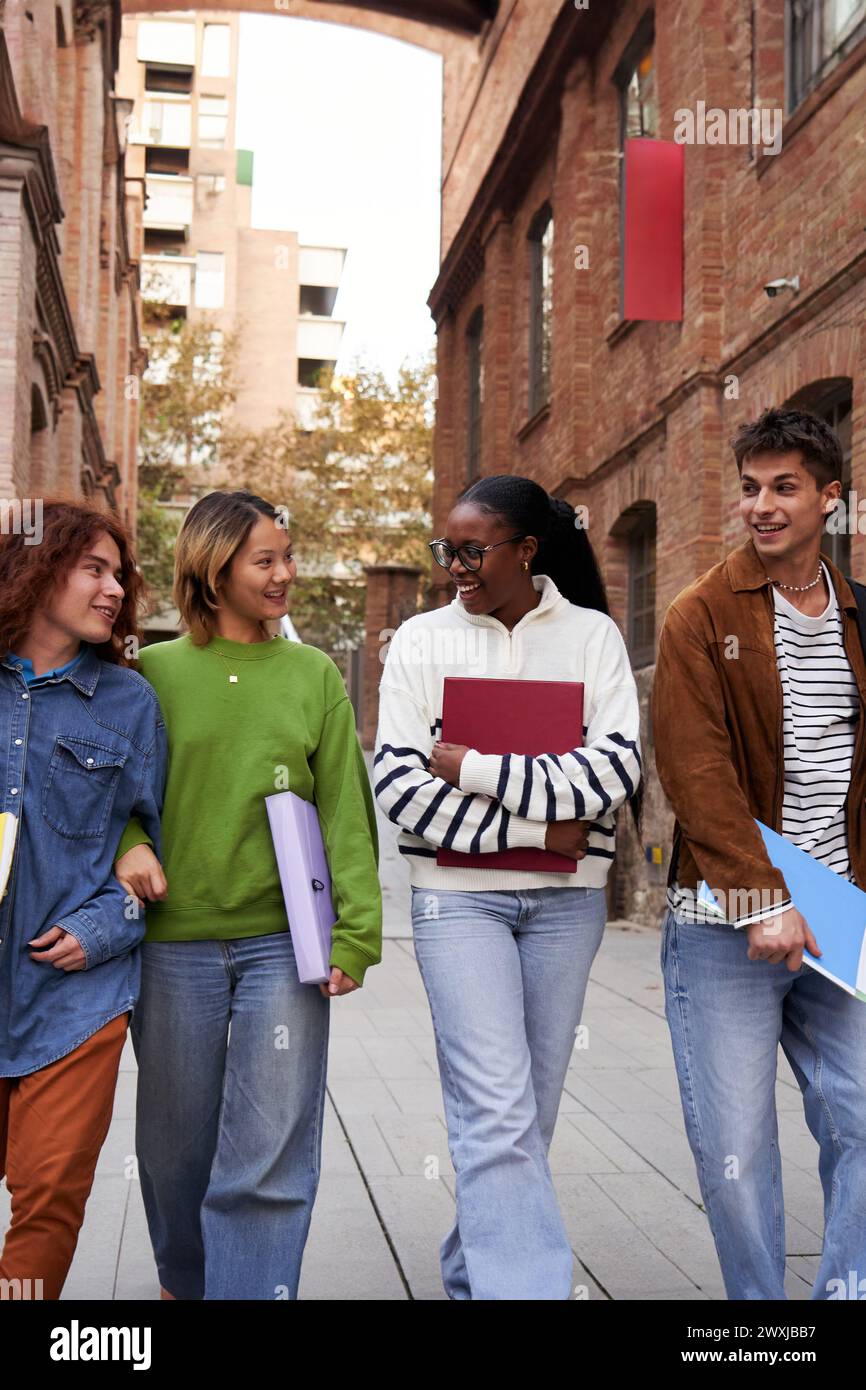 Internacional group of university students walking and talking at ...