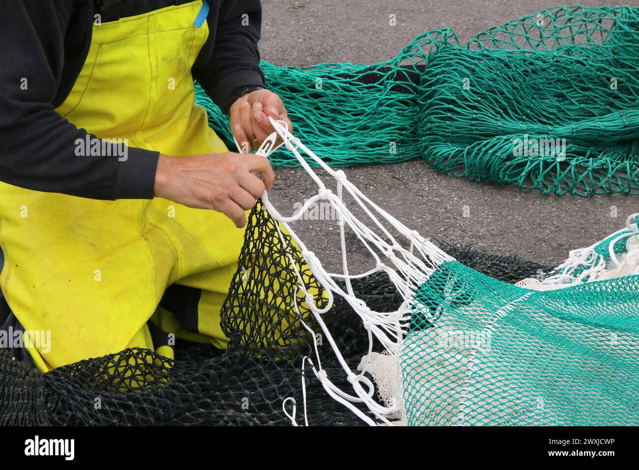Commercial fisherman mending nets hi-res stock photography and images ...