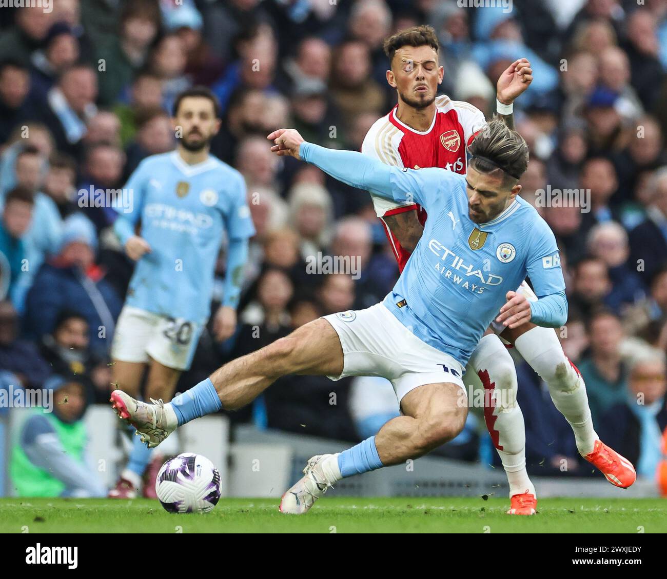 Jack Grealish of Manchester City and Ben White of Arsenal battle for ...