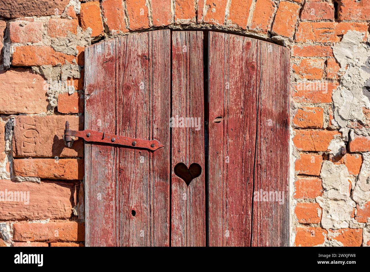Weathered wooden door with heart to the loo, loo door, sandstone and ...