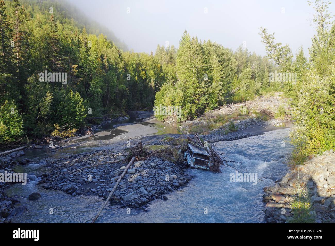 Wreckage of a car lying in a creek, Richardson Highway, Alaska, USA ...