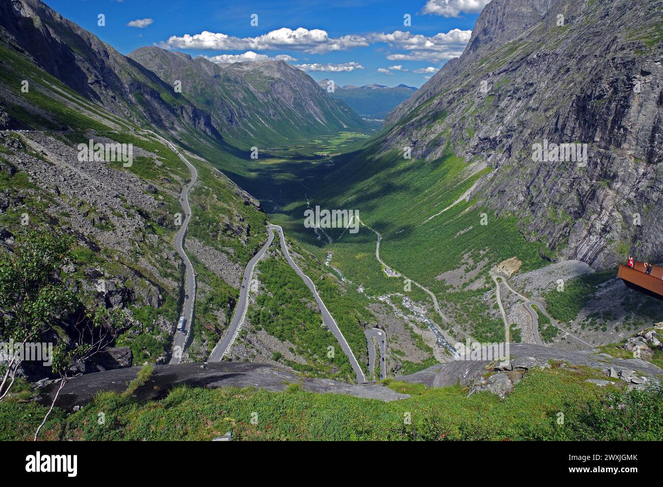 View over a winding mountain road and a narrow valley, rough rocks ...