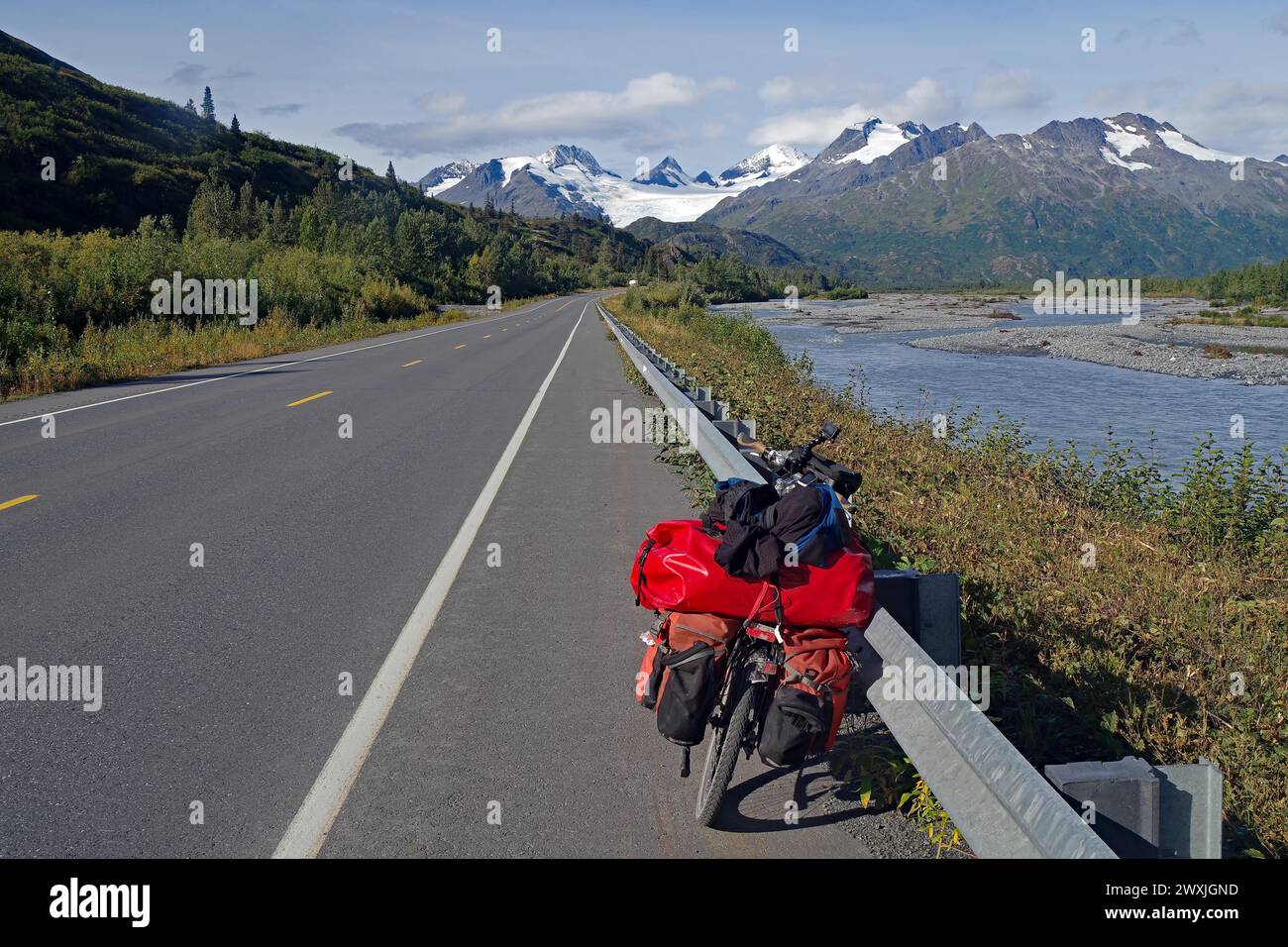 Bicycle leaning against the guardrail of a traffic-free road, glacier ...