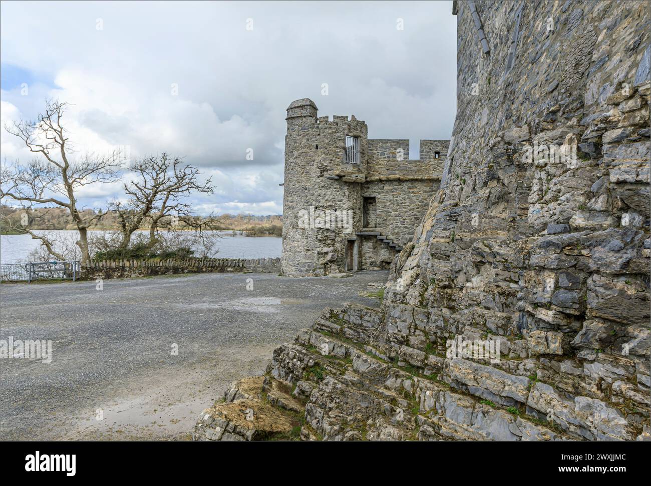 Looking around a corner at the turret of an ancient castle on a clear ...