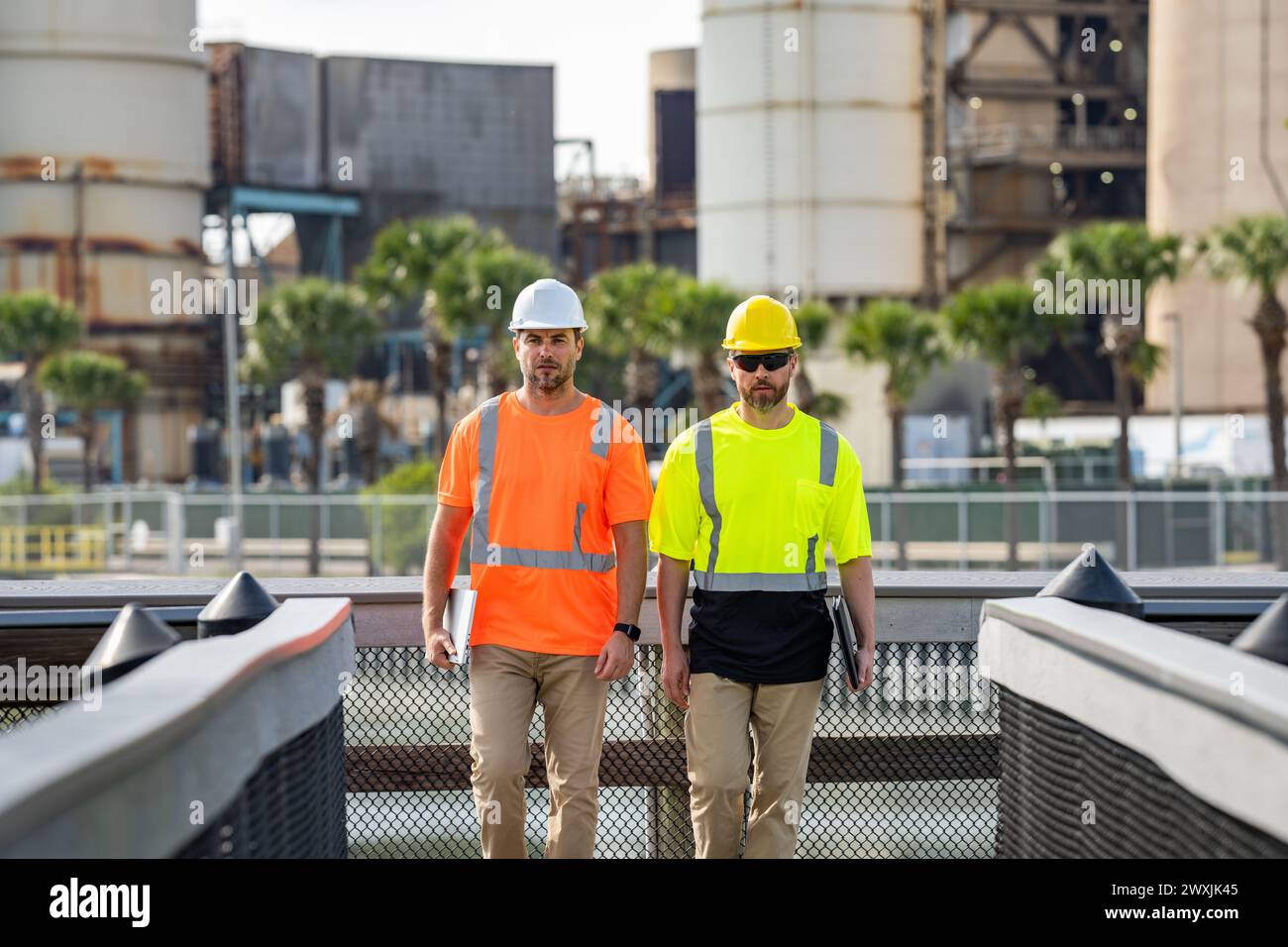 Professional heavy industry engineer workers in safety uniform and hard ...