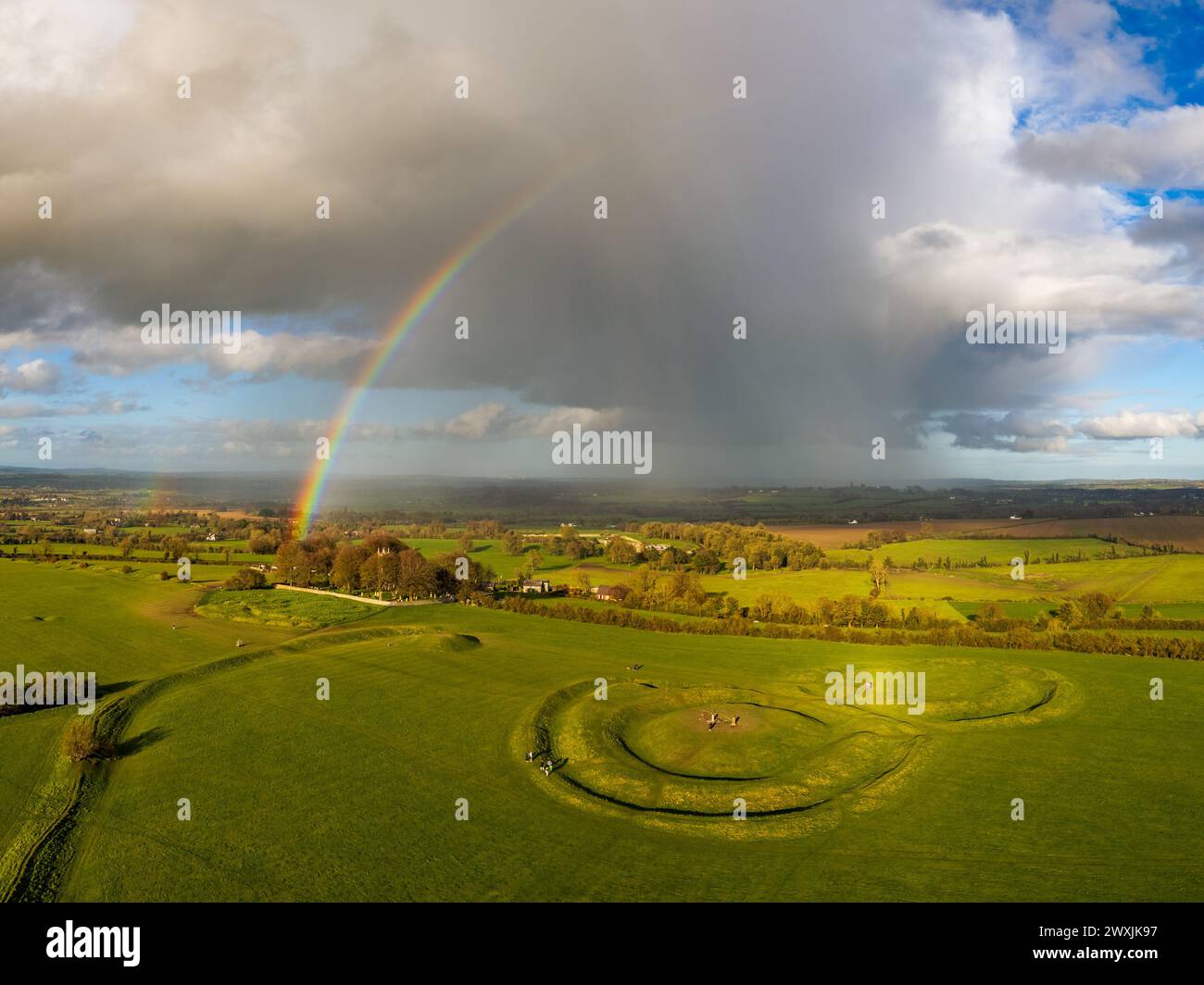 Rainbow and rain shower clearing the Hill of Tara Stock Photo - Alamy
