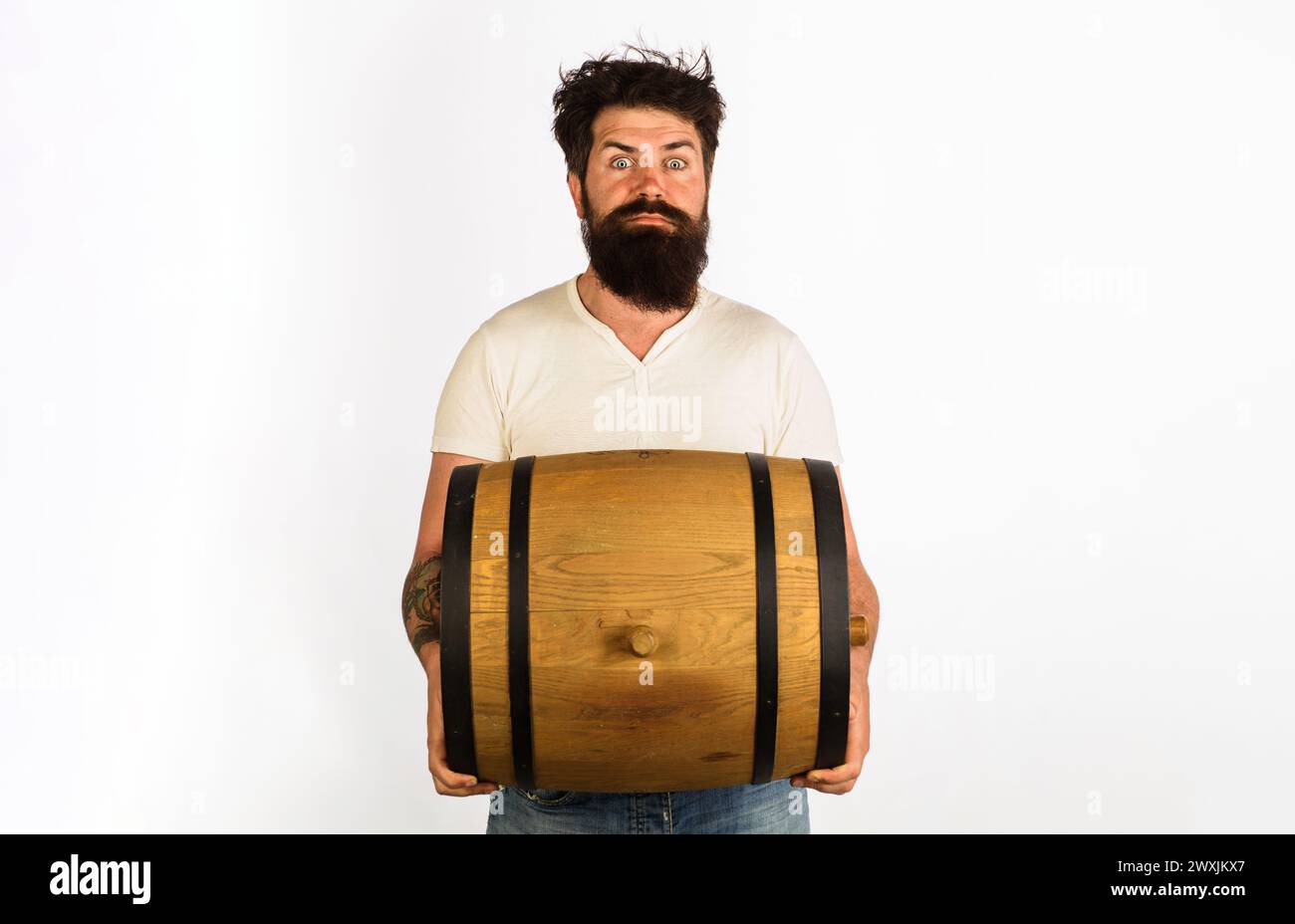 Surprised bearded man with oak barrel or cask of beer. Oktoberfest ...