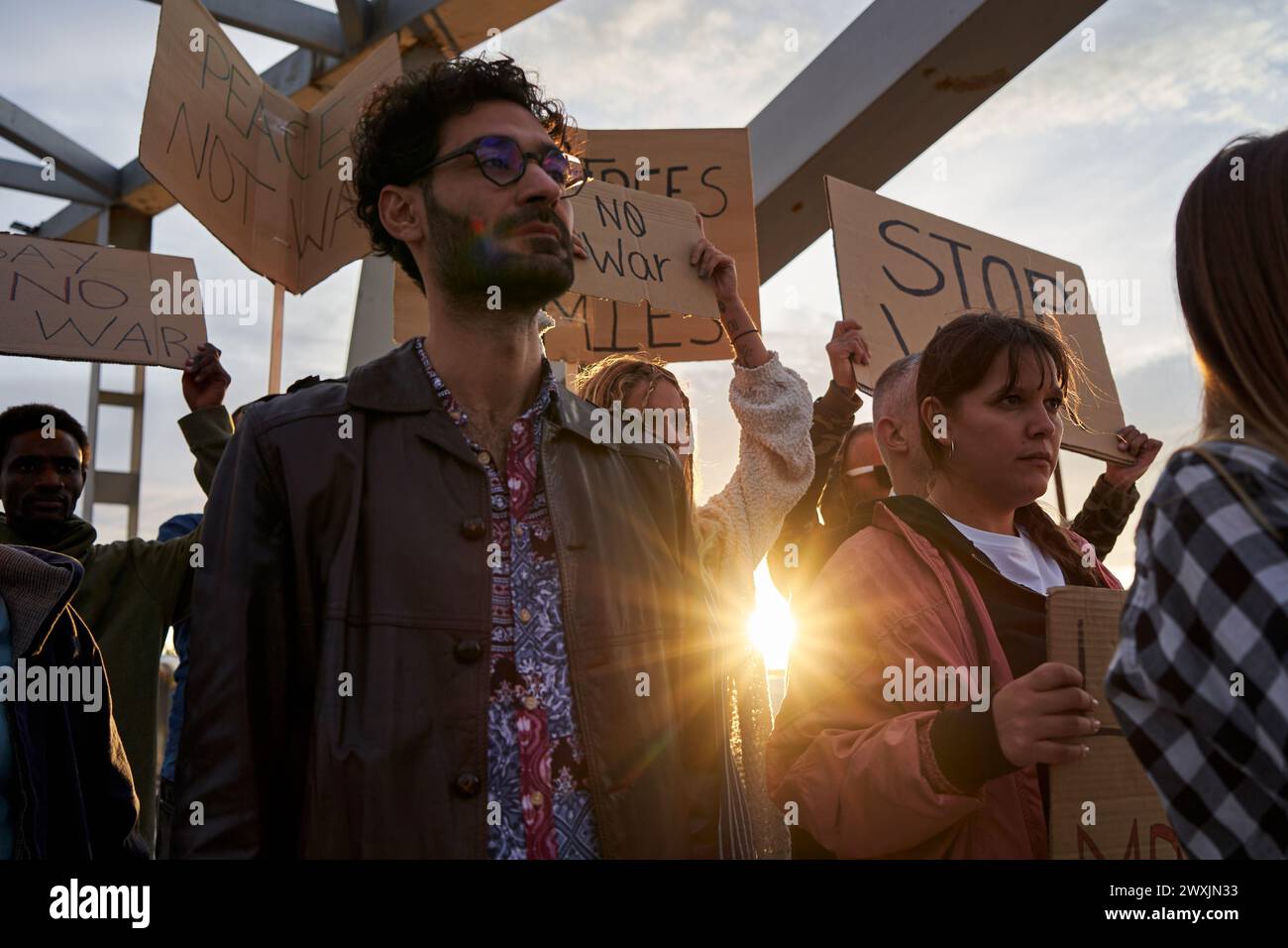 Group of activists at an anti-war protest walking and holding up ...