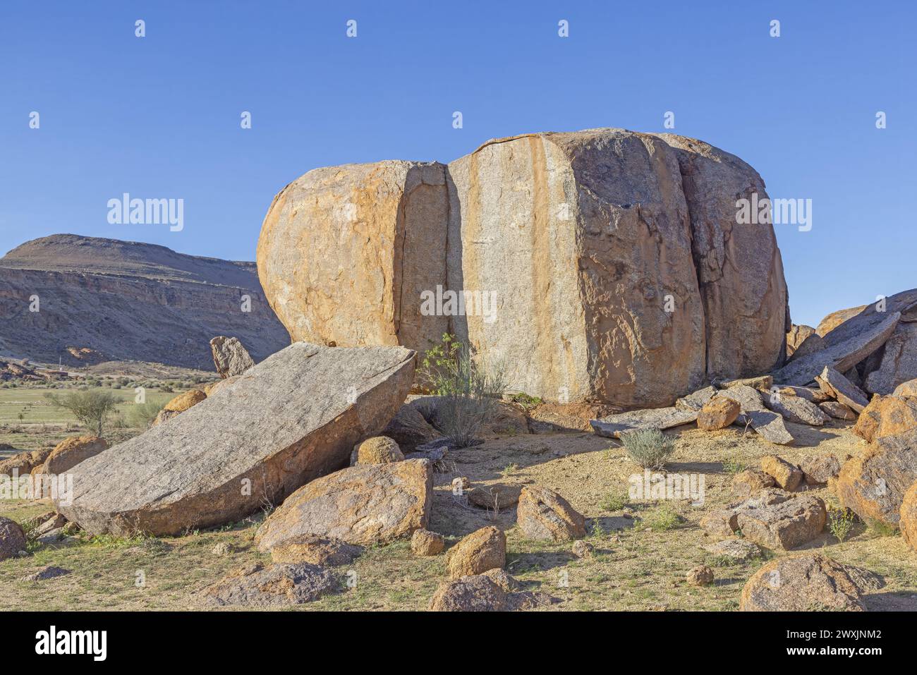 Giant split boulder in the south Namibian desert landscape under a ...
