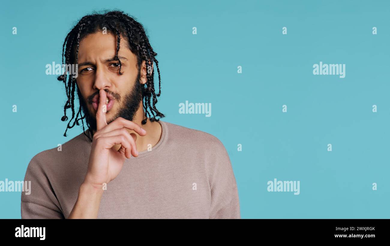 Annoyed Middle Eastern man doing shushing hand gesturing, irritated by ...