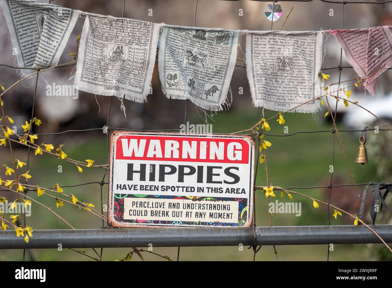 "Warning Hippies" sign and prayer flags, Imnaha, Oregon Stock Photo - Alamy