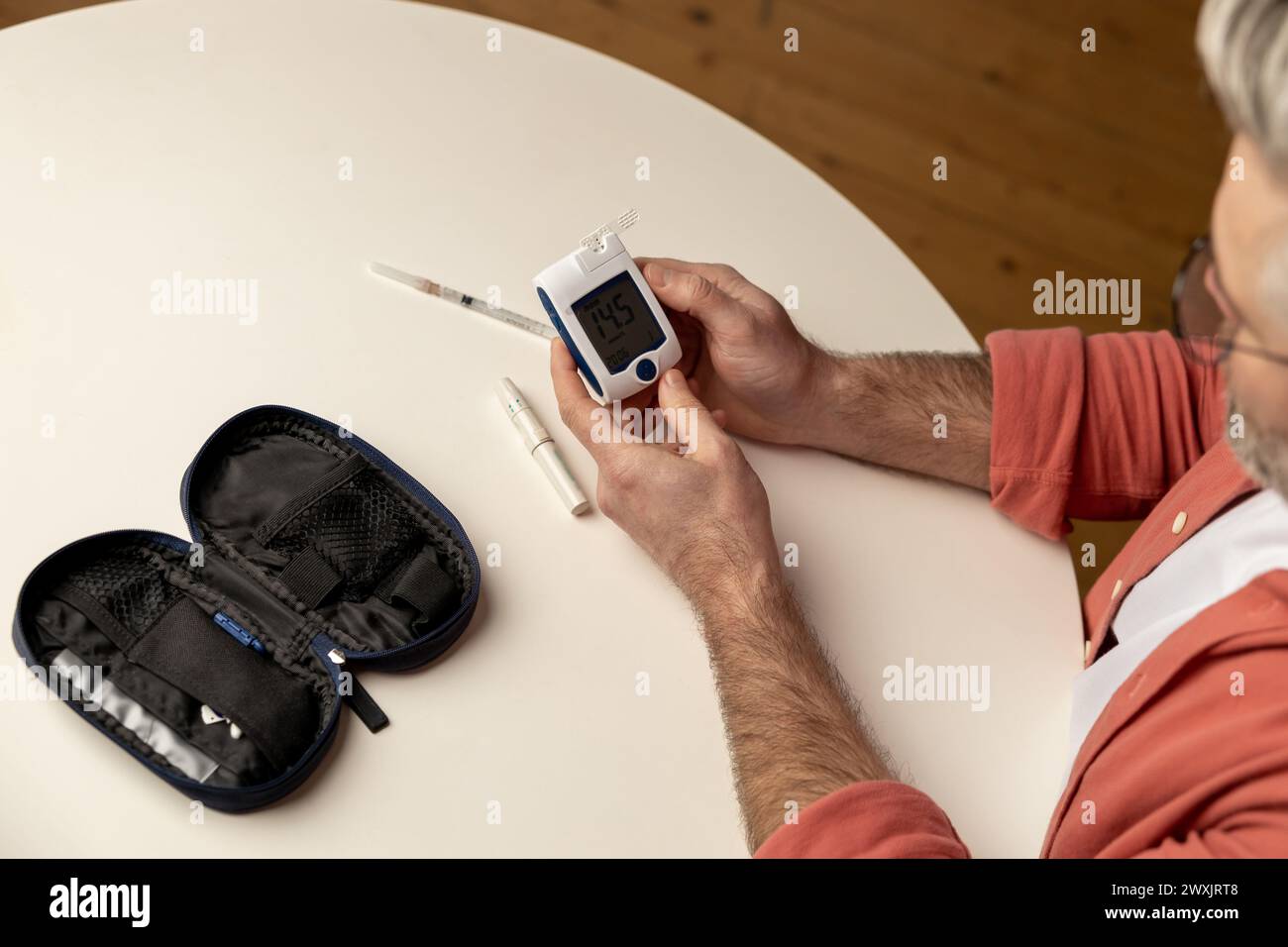 Unhealthy diabetic man checking level of sugar in blood with glucometer ...