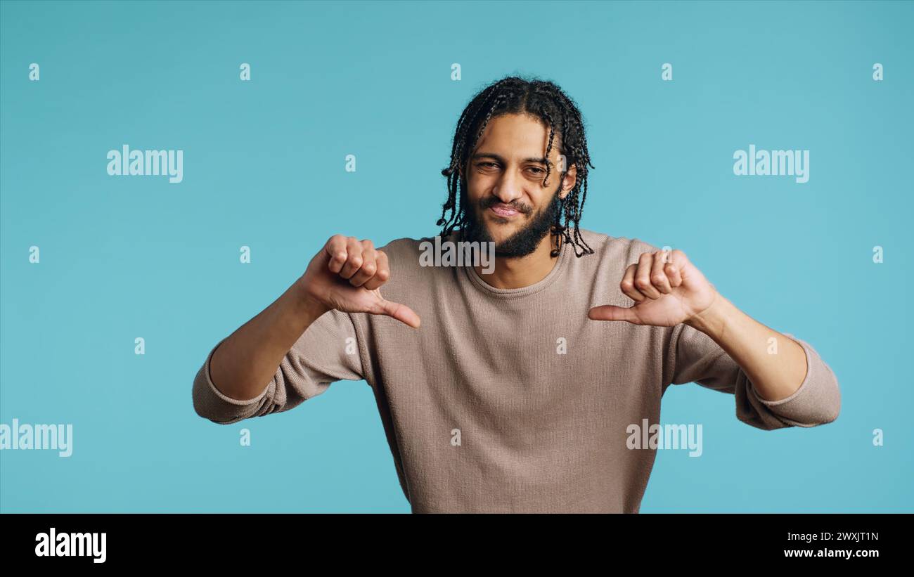 Upset Middle Eastern man showing thumbs down sign gesturing ...