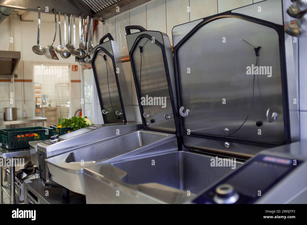 Industrial dishwasher in restaurant kitchen washing dishes Stock Photo ...