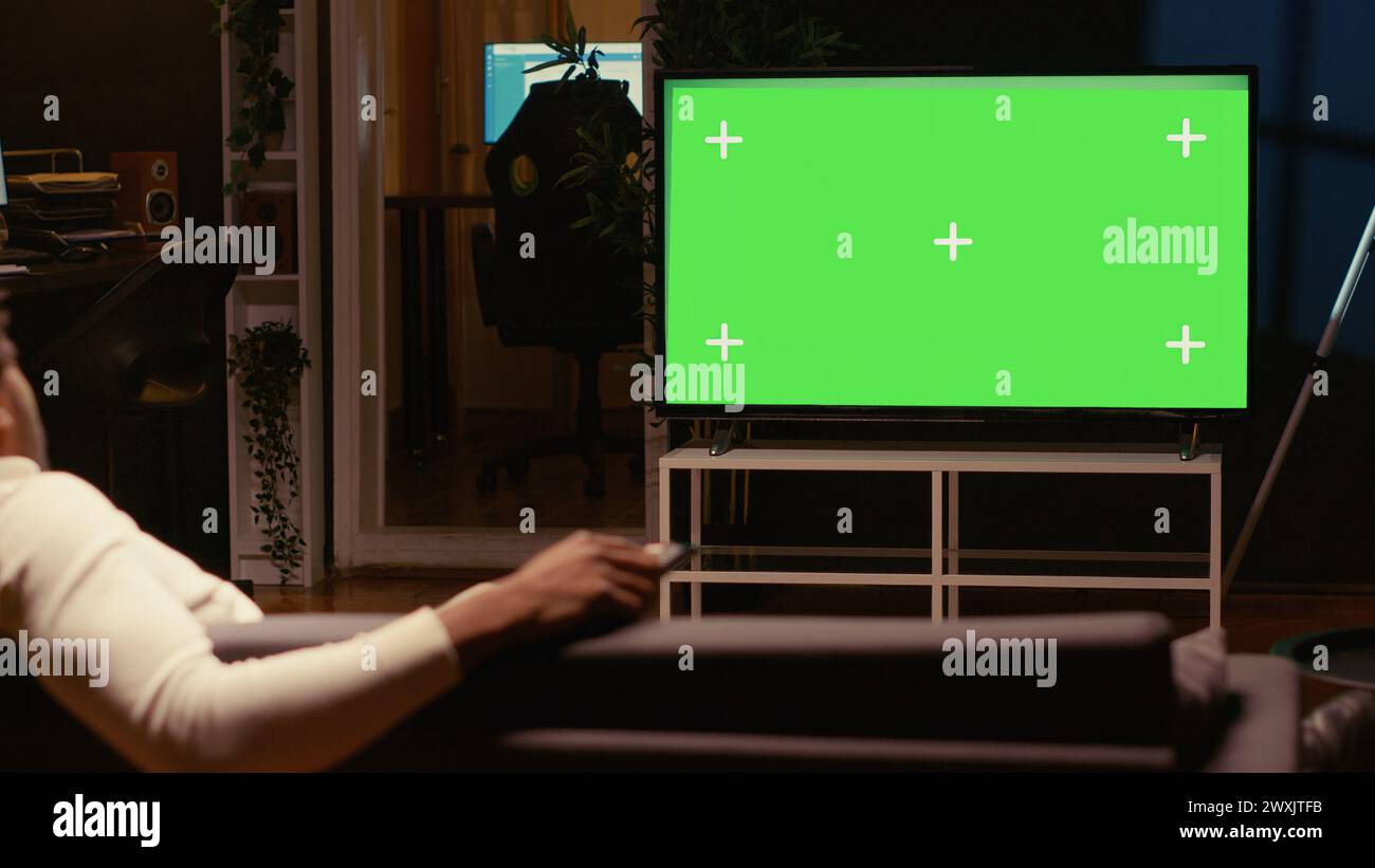 African american man using streaming services on mockup TV to binge ...
