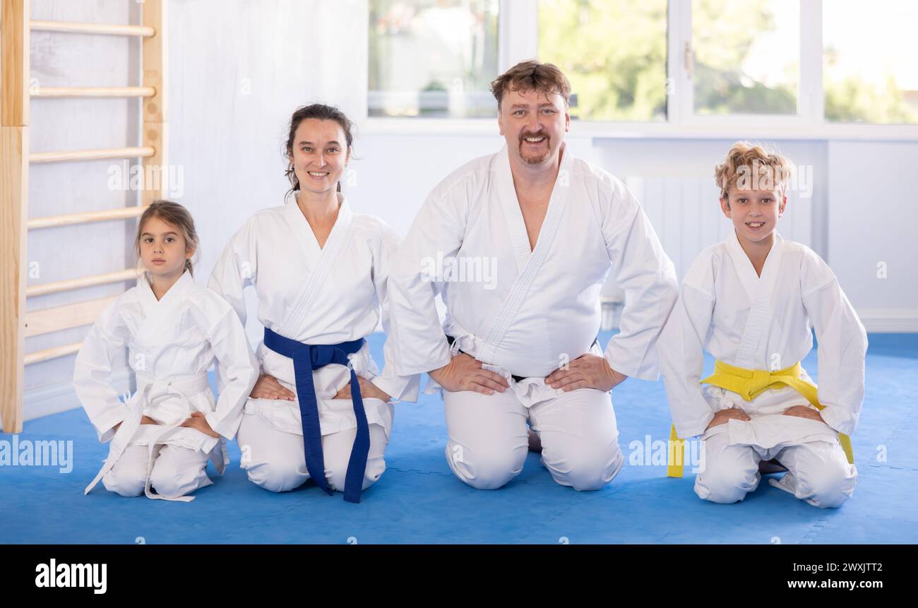Family of karatekas posing on floor in studio Stock Photo - Alamy