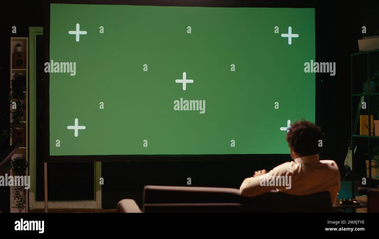 Man playing singleplayer videogames on isolated screen ultrawide TV in ...