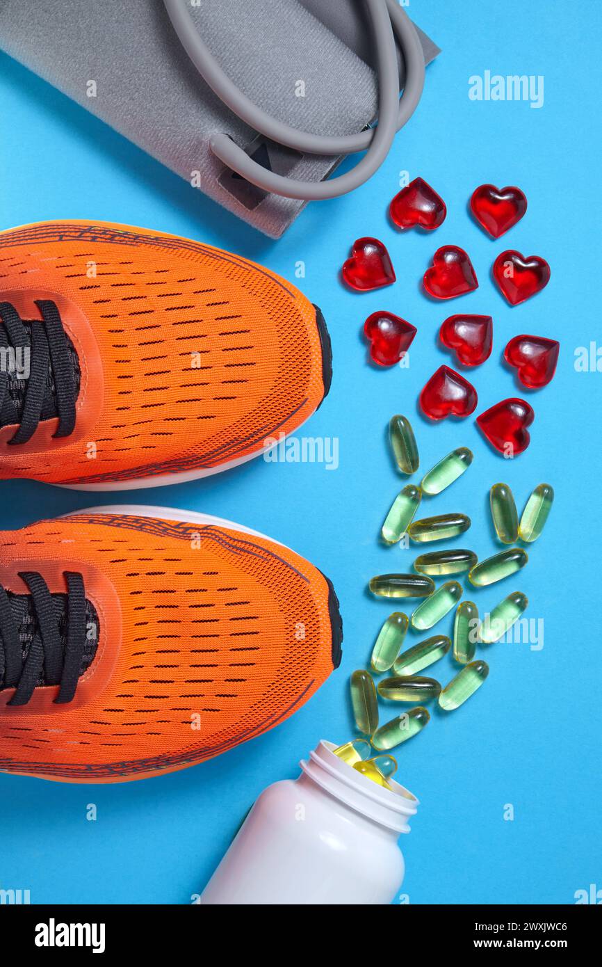 Yellow capsules of unsaturated fatty acids and red glass hearts ...