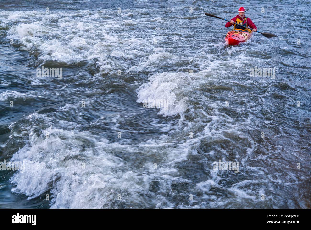 whitewater kayaker paddling upstream the river rapid Stock Photo - Alamy