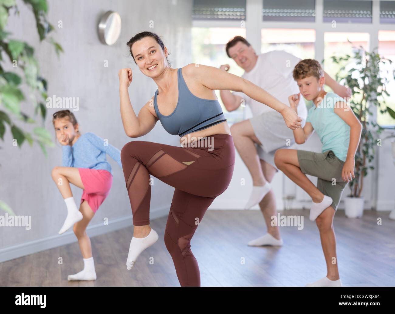 Family with two children dancing in studio Stock Photo - Alamy